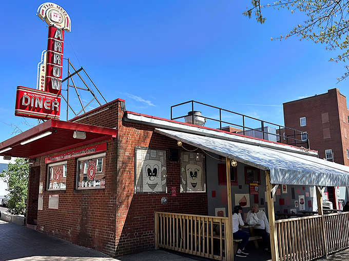 The iconic brick exterior of Red Arrow Diner proudly announces its status as a top-ten diner. Manchester's 24-hour beacon of breakfast bliss awaits hungry travelers.