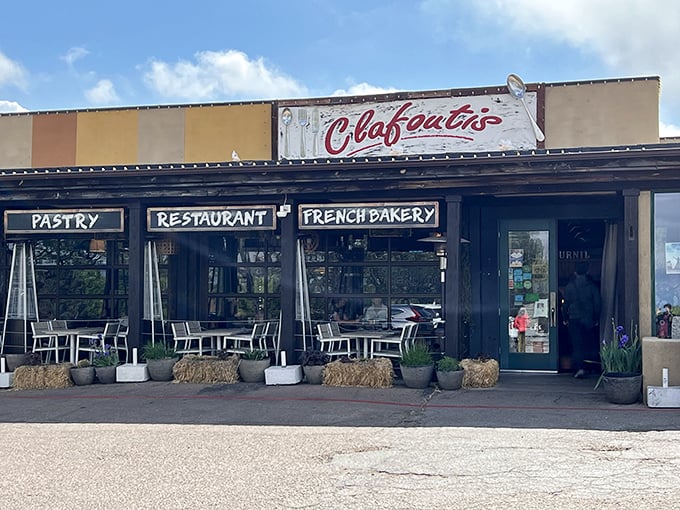 The unassuming exterior of Clafoutis beckons like a French postcard come to life, complete with charming patio seating perfect for people-watching with your pain au chocolat.