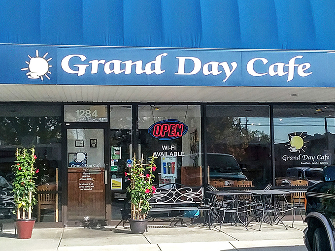 The blue awning of Grand Day Cafe beckons like a breakfast lighthouse guiding hungry souls to hash brown paradise.