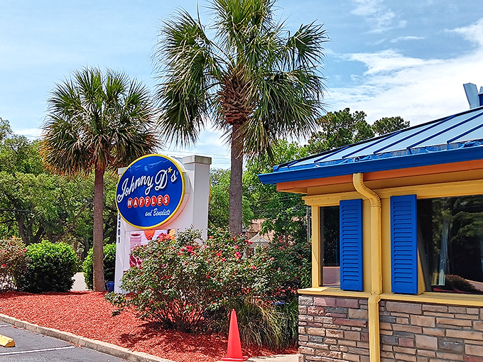 The bright blue roof and cheerful yellow walls of Johnny D's beckon like a breakfast lighthouse, promising delicious refuge from ordinary morning meals.