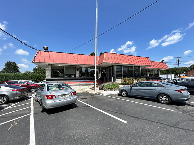 The classic red roof of Route 1 Diner stands like a beacon for hungry travelers, complete with American flag proudly waving &ndash; a true Jersey roadside landmark.