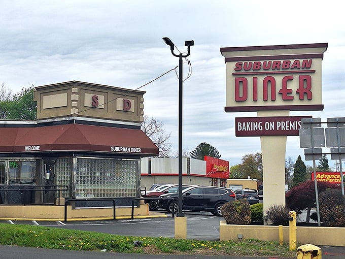 The iconic Suburban Diner sign promises "BAKING ON PREMIS" &ndash; a charming typo that somehow makes the anticipation of fresh-baked goods even more endearing. 