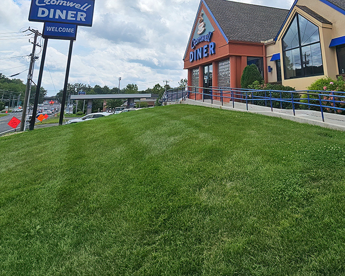The iconic blue sign of Cromwell Diner stands like a beacon for hungry travelers, promising comfort food salvation just off Route 372. 