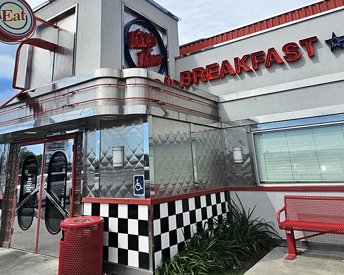 The gleaming chrome exterior of Dixie's Diner shines like a beacon of hope for hungry travelers, its classic checkerboard trim promising authentic American comfort food inside.