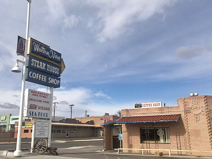 The neon-adorned vintage sign stands like a sentinel of comfort food, promising steaks, seafood, and the timeless appeal of a genuine coffee shop experience.