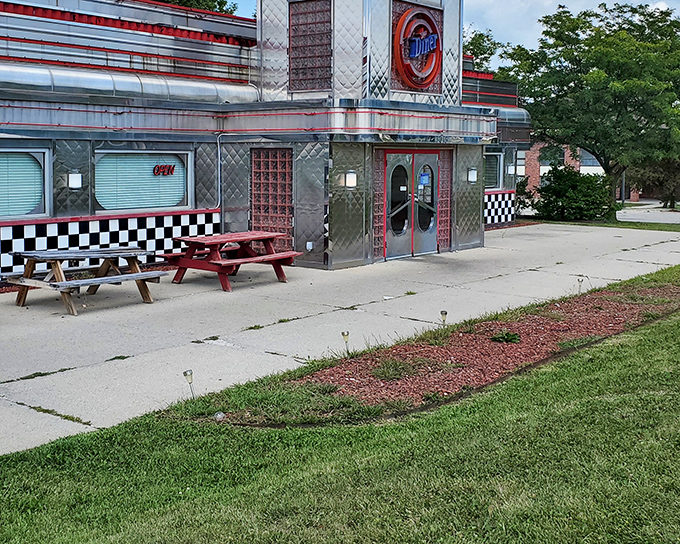 The gleaming stainless steel exterior with classic checkered trim promises a time-traveling culinary adventure before you even step inside.