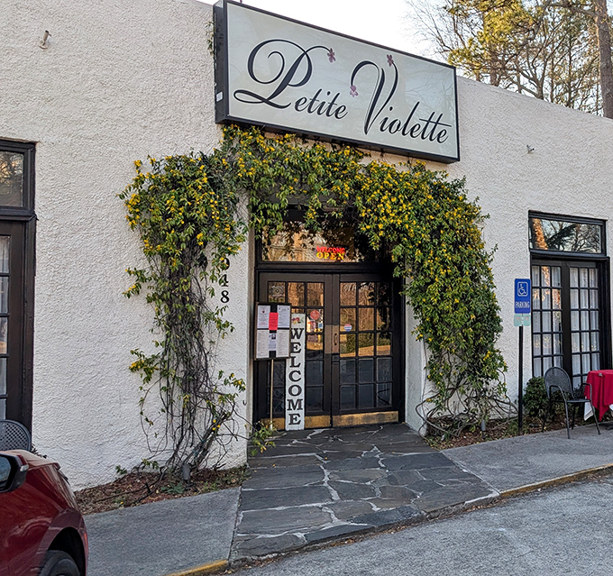 The unassuming exterior of Petite Violette belies the culinary treasures within, like finding a Michelin star hiding behind a garden trellis.