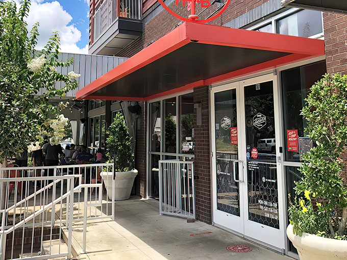 The iconic red rooster stands guard outside Hattie B's, a beacon of spicy salvation for heat-seekers across Alabama.