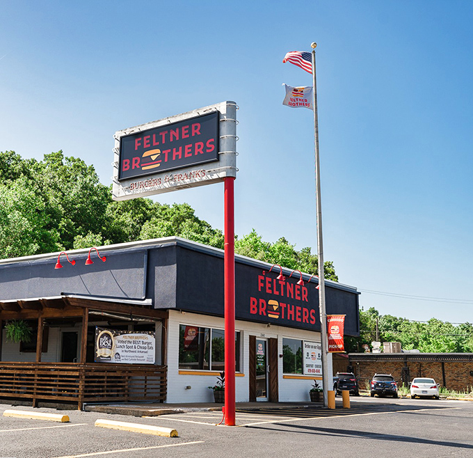 The red and black signage stands like a beacon of burger hope against the Arkansas sky. Simple, straightforward, and promising delicious things inside.