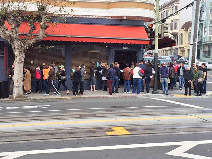 The red awning and line stretching down the block tells you everything &ndash; this isn't just breakfast, it's an event worth waiting for.