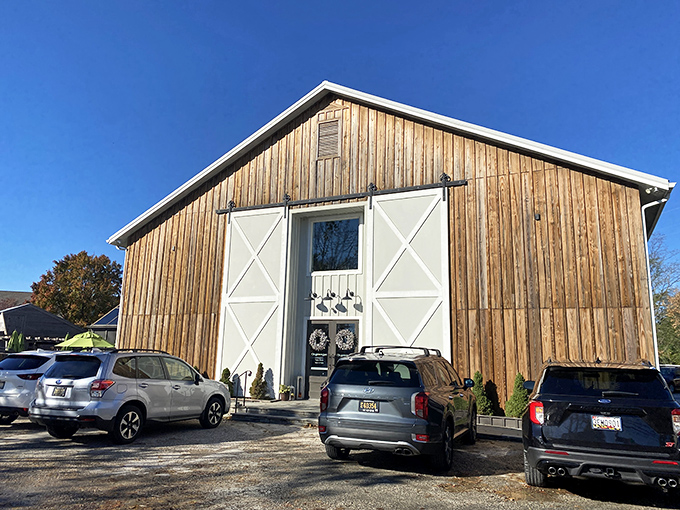 The rustic barn-like exterior of The Station on Kings beckons with its striking white barn doors&mdash;architectural simplicity that promises culinary sophistication inside.