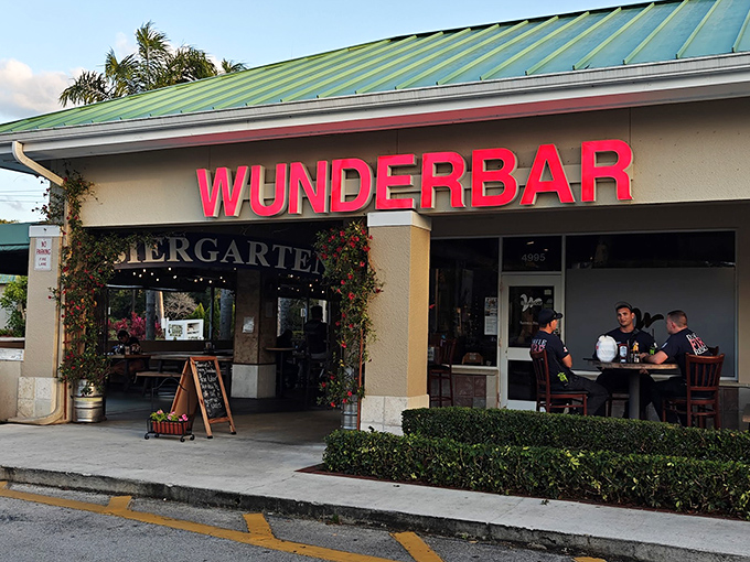 The green-roofed oasis of Wunderbar beckons with its vibrant red signage and lush entrance &ndash; a little slice of Bavaria hiding in plain sight.