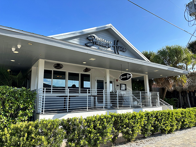 The coastal charm of Summer House beckons like an old friend, its crisp white exterior and lush landscaping promising culinary adventures within.