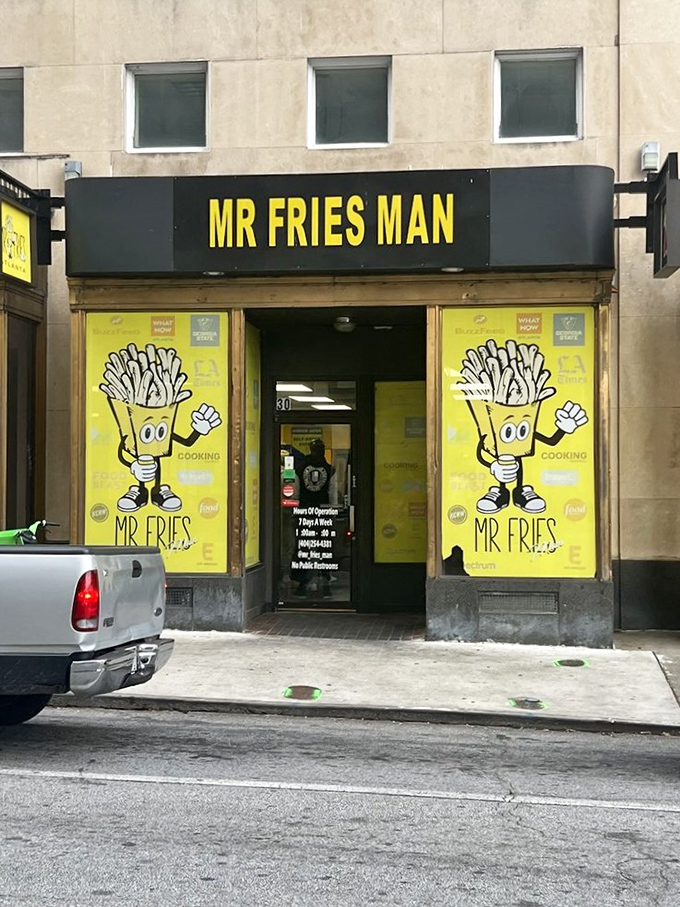 The bright yellow storefront stands out like a beacon of potato promise, with the cartoon fry mascot practically waving you inside.
