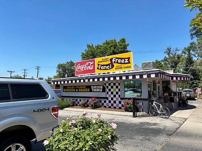 The checkered facade of Fanci Freez stands like a time portal to simpler days, when drive-thrus were social hubs and calories weren't counted, just savored. 