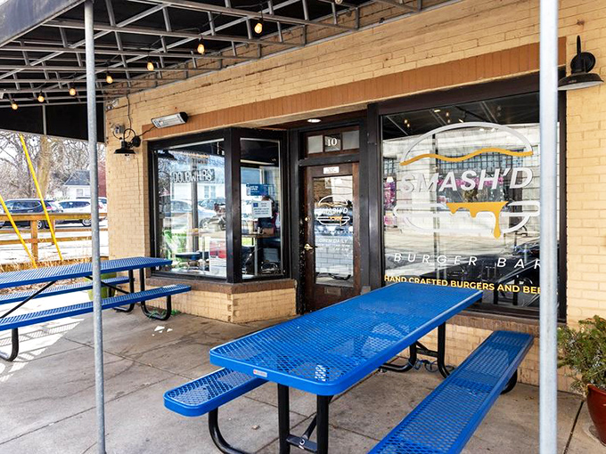 The bright blue picnic tables outside Smash'd Burger Bar are like a beacon calling to hungry travelers. No pretension here, just the promise of honest-to-goodness flavor.