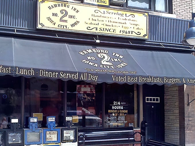 The iconic yellow awning of Hamburg Inn No. 2 beckons like a breakfast lighthouse on Linn Street, promising pieshakes and happiness since 1948.