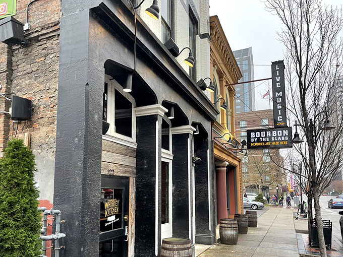Historic brick meets modern Louisville skyline at Merle's Whiskey Kitchen, where bourbon country's culinary traditions come alive in the heart of Whiskey Row.