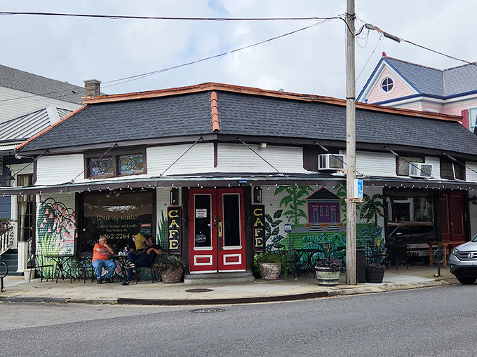 The corner cafe with its iconic red doors and palm tree murals stands like a breakfast beacon in Algiers Point, inviting hungry souls to step inside.