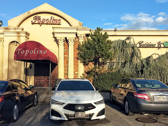 The unassuming exterior of Topolino hides culinary treasures within, like finding a Rolex in a paper bag. That red awning practically winks at you.
