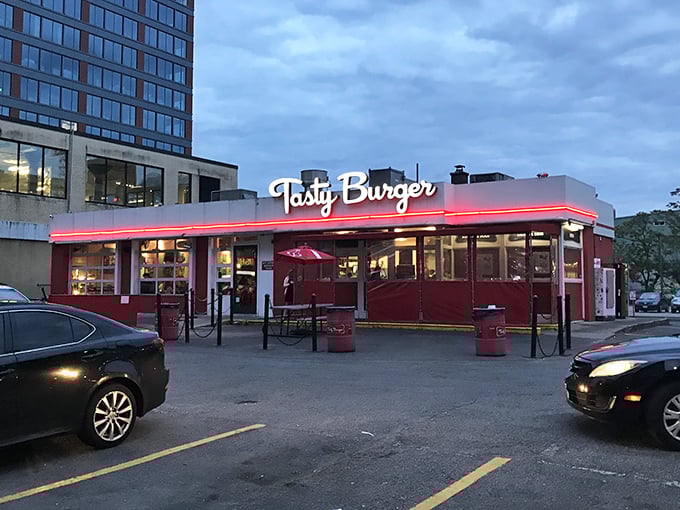 The neon glow of Tasty Burger's sign against the twilight sky beckons like a lighthouse for the hungry and flavor-deprived. Boston's answer to late-night cravings.