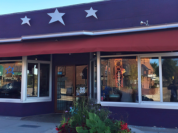 The purple facade with its cheerful red awning and hanging flower baskets isn't just eye-catching&mdash;it's nature's way of saying "breakfast is served!"