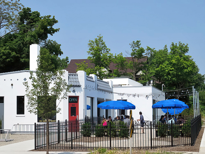 The patio paradise at Donkey Taqueria sits beneath string lights, with the iconic purple Victorian house creating a perfect backdrop for your taco-fueled evening.