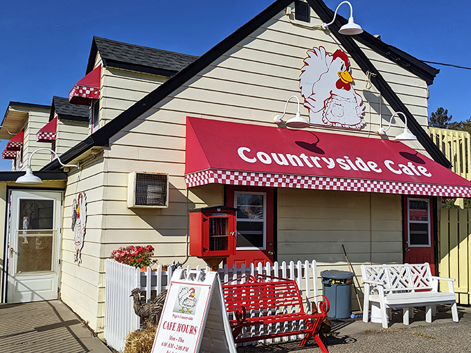 The iconic chicken mascot stands guard atop this cheerful yellow building, promising breakfast salvation to all who enter.
