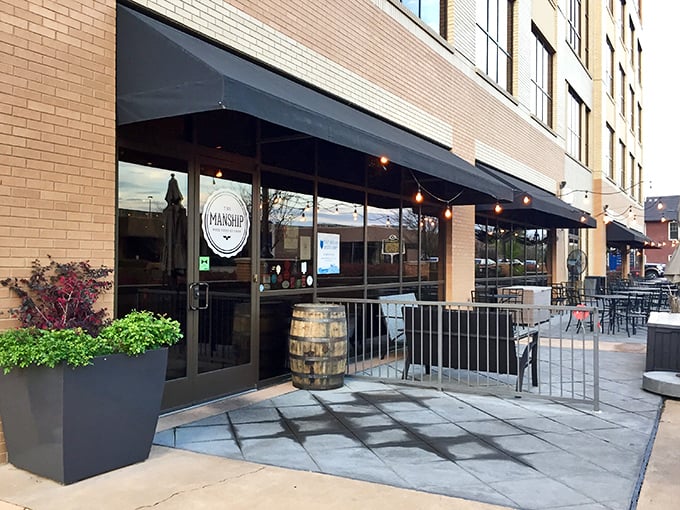 The Manship's elegant brick exterior with vibrant red hedges offers a hint of the culinary magic happening inside this Jackson gem.