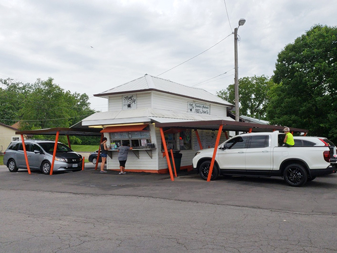 The humble white building with its distinctive orange-red supports stands like a time capsule of American drive-in culture. Simple perfection awaits.