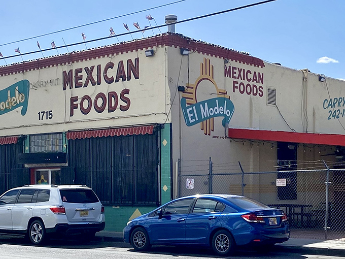 The unassuming exterior of El Modelo stands like a culinary lighthouse in Albuquerque's Barelas neighborhood, beckoning hungry pilgrims with its iconic Zia symbol.