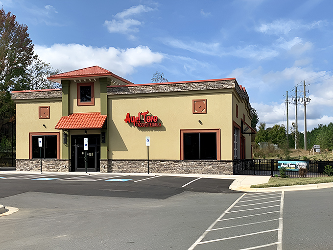 The golden-hued exterior of Aye! Toro stands like a beacon of culinary promise in Pittsboro, its terracotta accents and stonework hinting at the authentic flavors waiting inside.