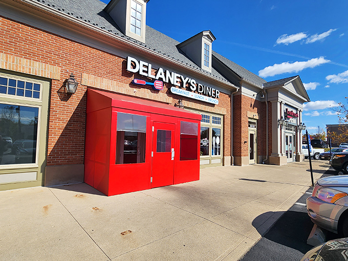 The brick facade and bright red doors of Delaney's Diner stand like a beacon of breakfast hope on East Main Street in Columbus.