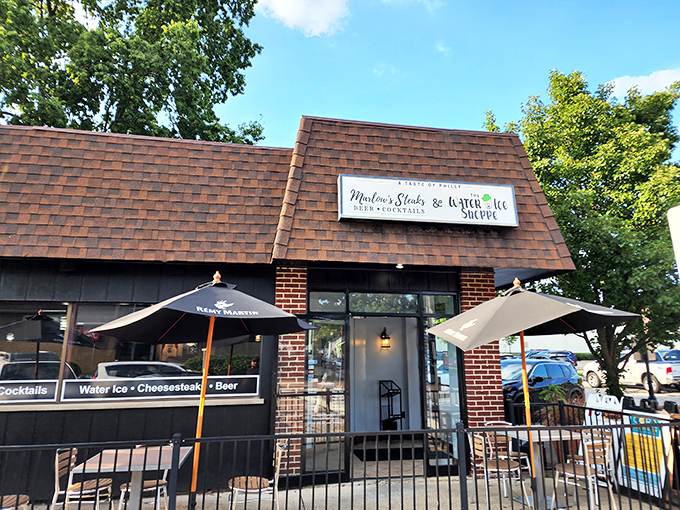 Marlow's unassuming exterior might not stop traffic, but that brown-shingled roof shelters cheesesteak paradise. Those patio umbrellas hint at the treasures waiting inside.