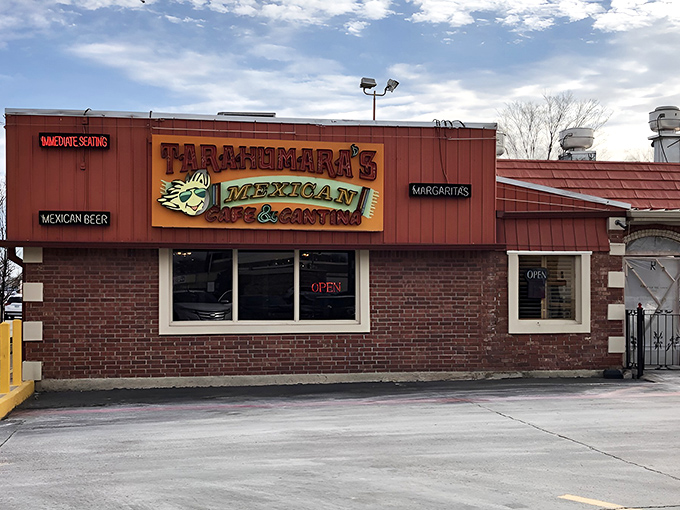 The bright red exterior of Tarahumara's stands like a beacon of culinary promise in Norman, beckoning hungry travelers with its distinctive signage and welcoming patio.
