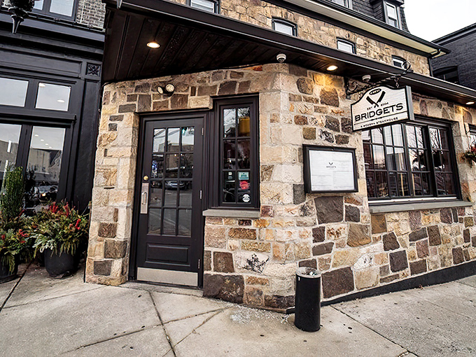 The unassuming stone exterior of Bridget's Steakhouse in Ambler hides culinary treasures within, like a delicious secret waiting to be discovered.