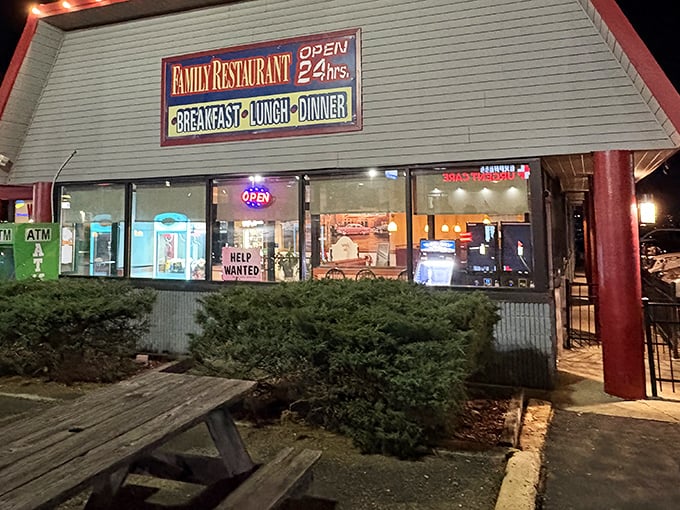 The neon glow of "OPEN 24 hrs" isn't just a sign&mdash;it's a beacon of hope for hungry souls at any hour. Classic diner architecture with a promise of comfort inside. 