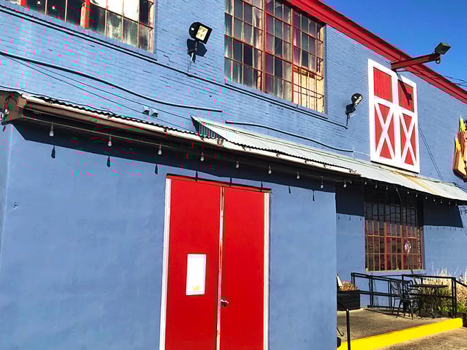 The blue exterior with its red barn door isn't trying to impress anyone&mdash;until you smell what's happening inside. BBQ paradise awaits.