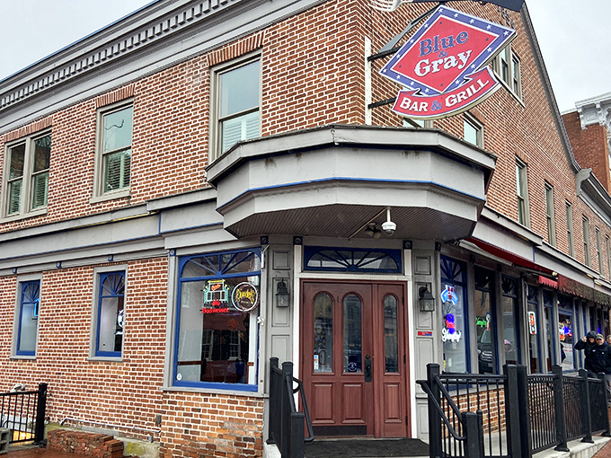 The red awnings of Blue & Gray Bar & Grill beckon like culinary semaphore signals amidst historic Gettysburg's brick backdrop. A sight for hungry eyes.