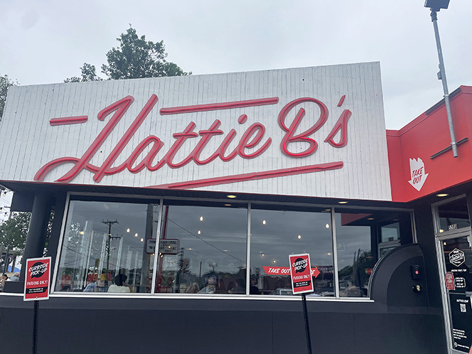 The iconic red script against white beckons like a siren song to heat-seekers. This Nashville landmark promises pleasure and pain in equal measure.