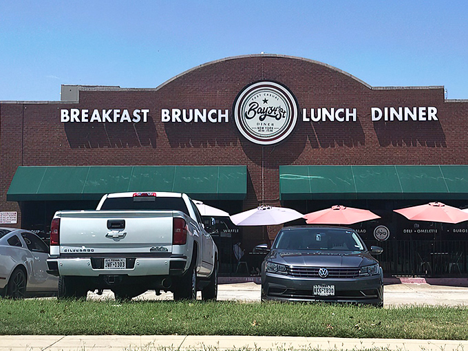 The brick facade with teal awnings isn't just inviting&mdash;it's practically shouting "Come get breakfast!" Those white picnic tables are waiting for your morning revelation.
