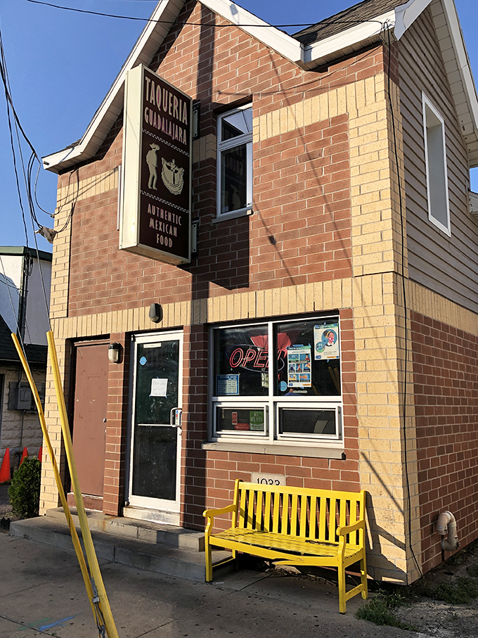 The unassuming brick exterior with that eye-catching pink bench is like a secret handshake &ndash; those who know, know this is where Madison's burrito magic happens.