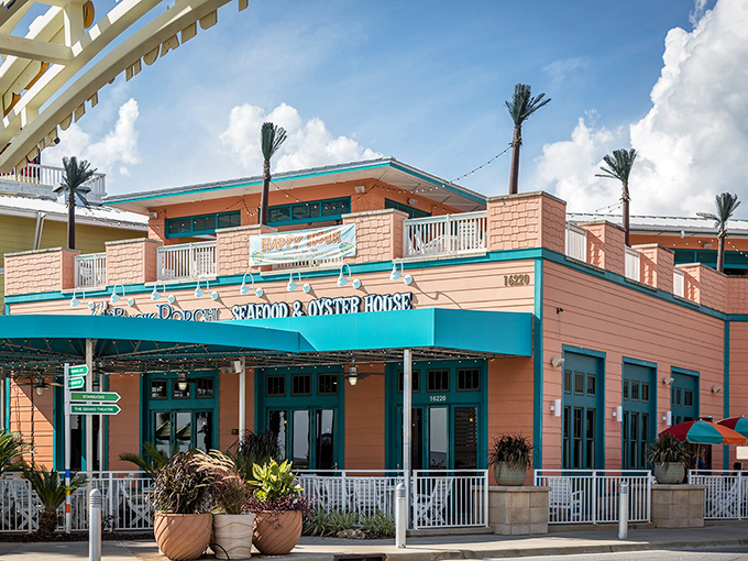 The salmon-pink exterior with turquoise trim isn't trying to be fancy&mdash;it's the architectural equivalent of saying "kick off your flip-flops and stay awhile."