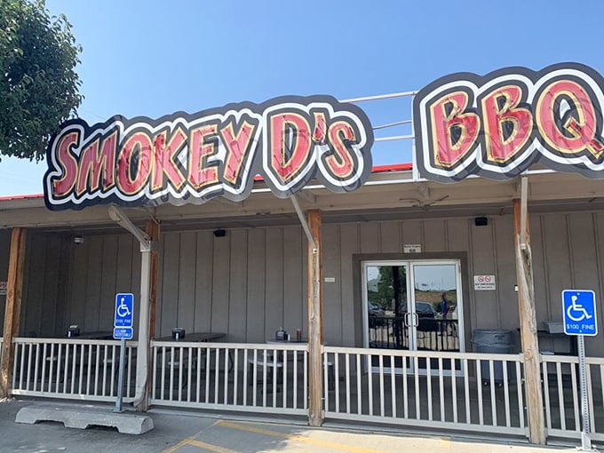 The neon-red sign of Smokey D's BBQ glows like a beacon for hungry souls, promising salvation through smoke and meat in Des Moines.