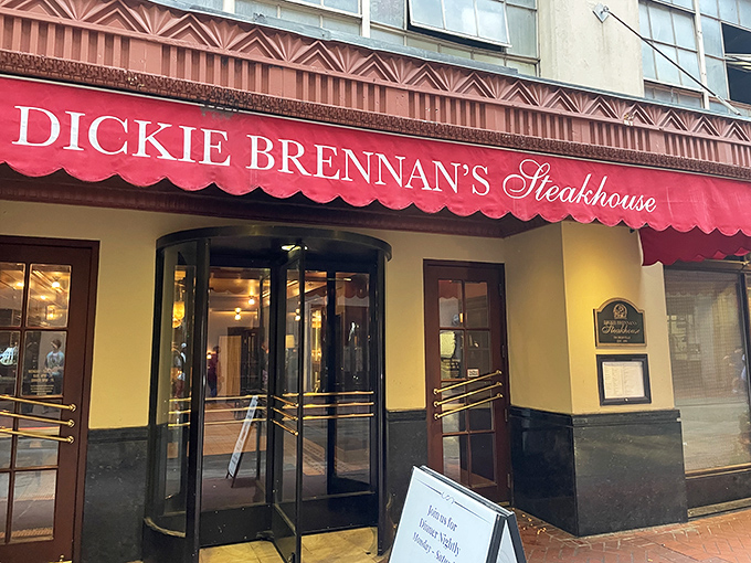 The unassuming red awning of Dickie Brennan's Steakhouse beckons from the historic French Quarter, promising culinary treasures that outshine its modest exterior. 