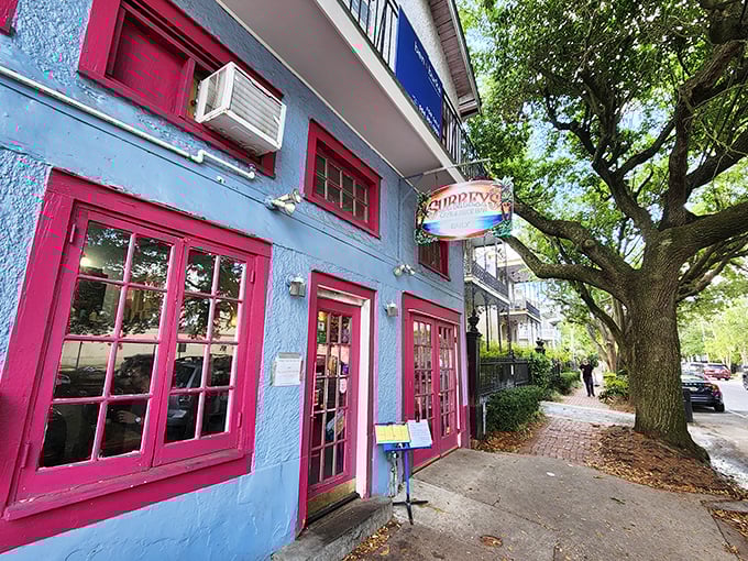 The pink-trimmed facade of Surrey's stands out on Magazine Street like a culinary beacon, promising breakfast treasures within those colorful walls.