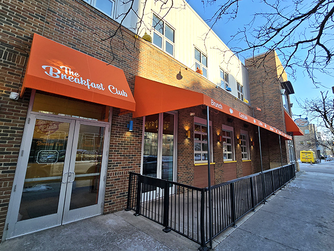 The vibrant red awning of The Breakfast Club MPLS beckons breakfast enthusiasts like a culinary lighthouse guiding hungry souls through Minneapolis mornings.