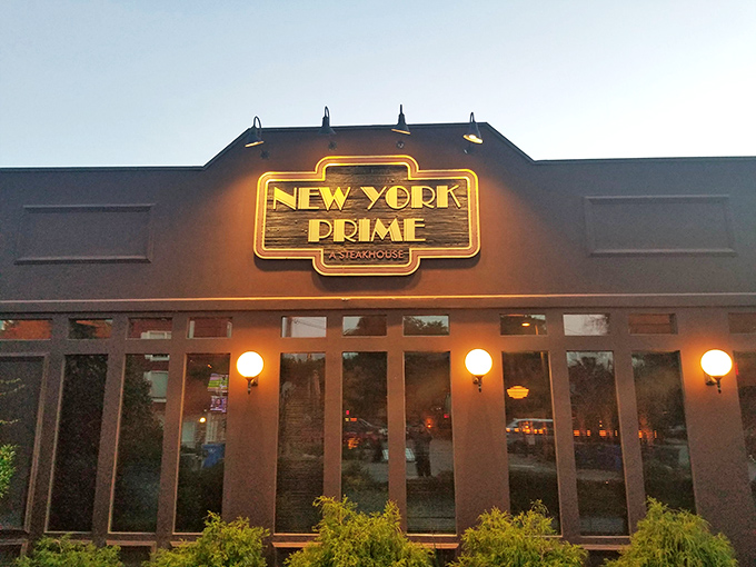 The neon glow of New York Prime beckons like a lighthouse for steak lovers&mdash;a humble exterior that belies the culinary treasures waiting inside.