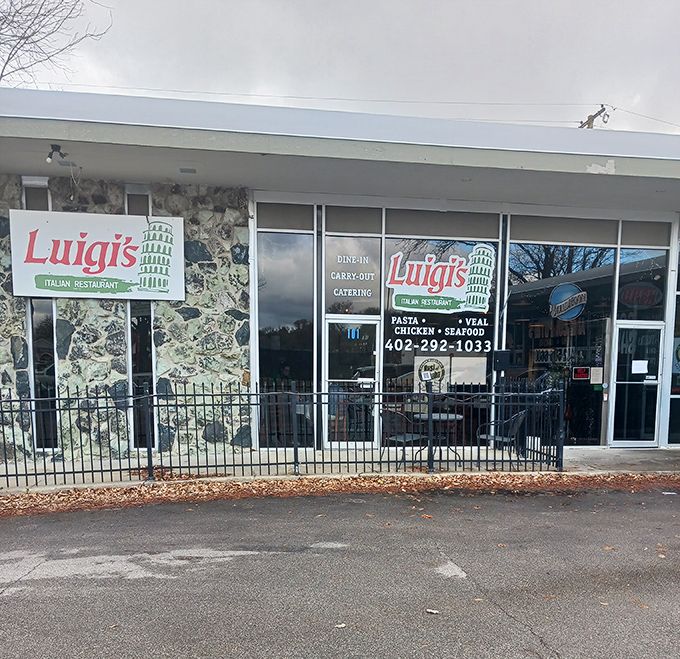 Luigi's stone facade creates that perfect "discovered gem" vibe, complete with the iconic Leaning Tower signage that promises authentic Italian flavors in Nebraska.