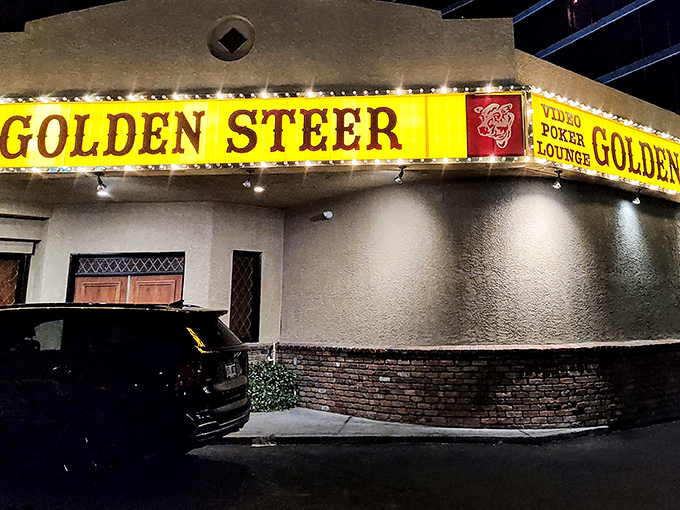The unassuming exterior of Golden Steer stands like a time capsule amid Vegas glitz, its vintage yellow sign promising authentic experiences inside.
